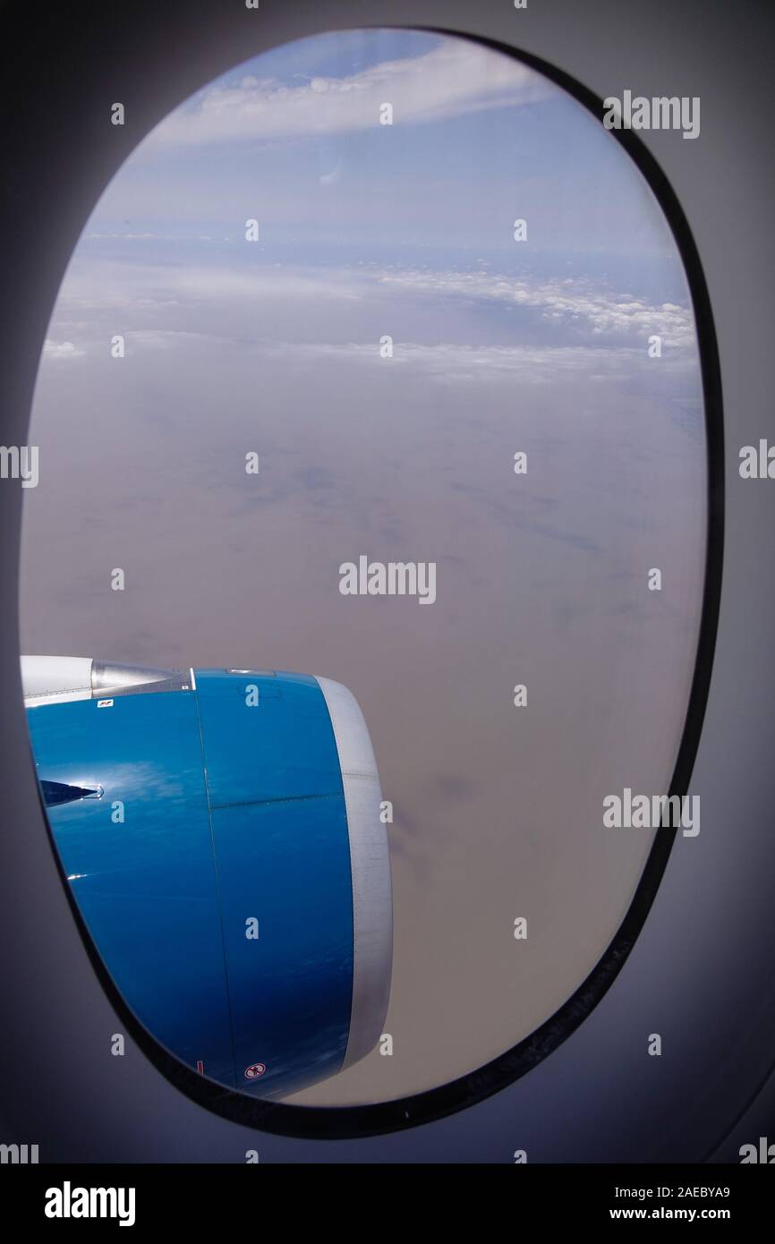 Blue engine of passenger airplane in the sky with cloudscape background ...