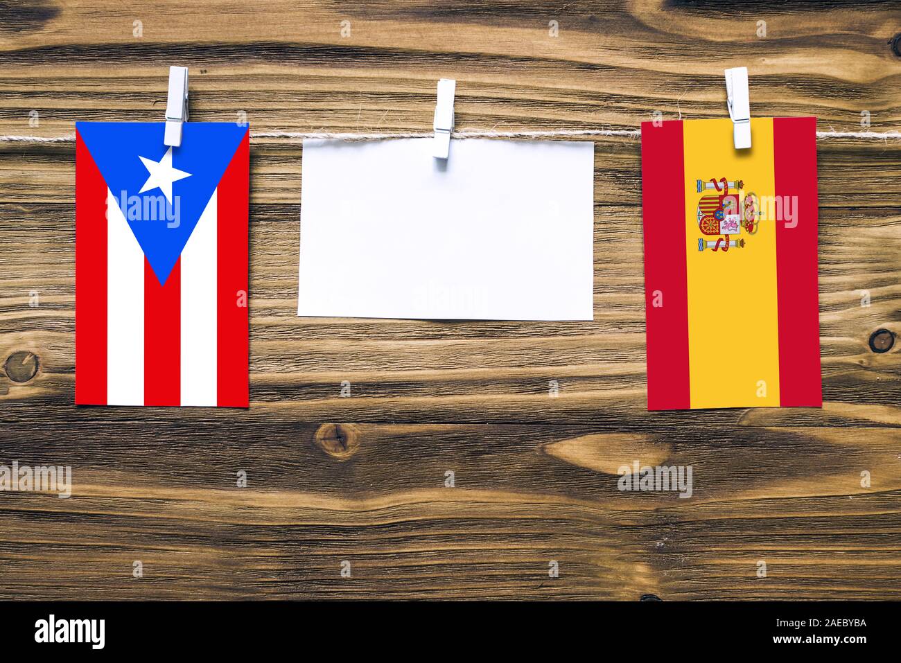 Hanging flags of Puerto Rico and Spain attached to rope with clothes ...