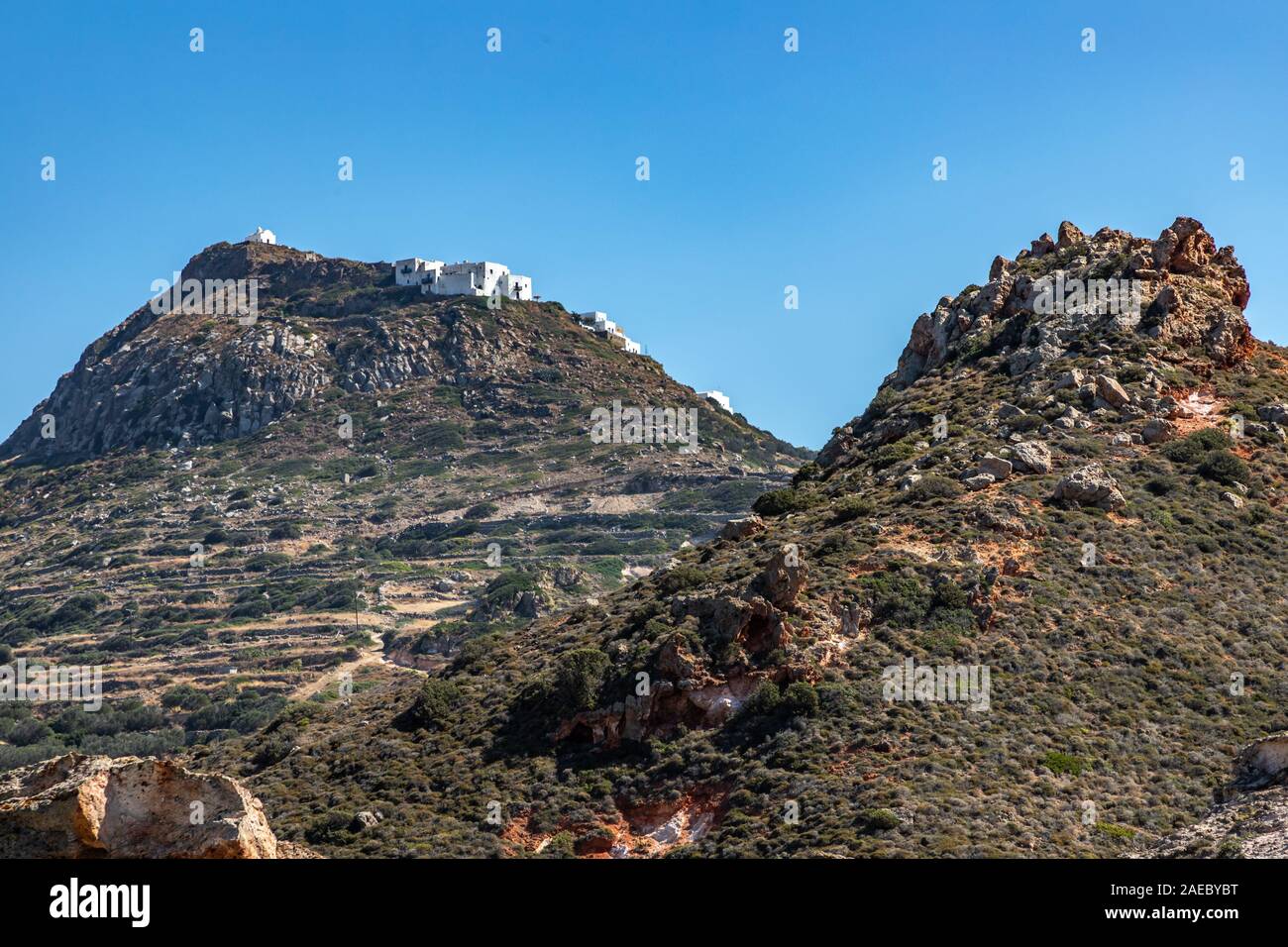 Mountain with houses and church in Plathiena beach, Milos, Greece Stock ...