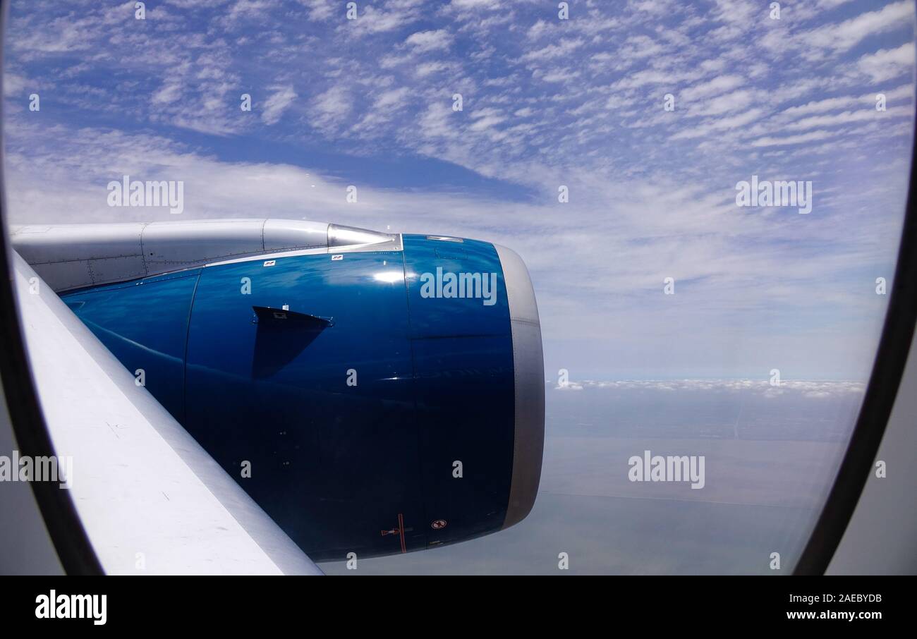 Blue engine of passenger airplane in the sky with cloudscape background ...