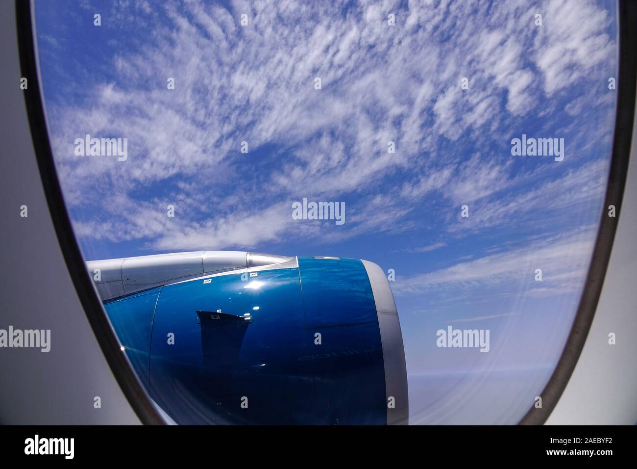 Blue engine of passenger airplane in the sky with cloudscape background ...