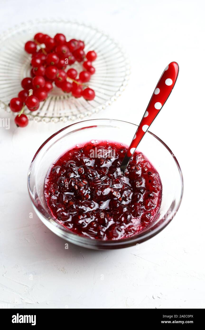 Homemade jam. Top view of red currant jam in a glass bowl and fresh ...