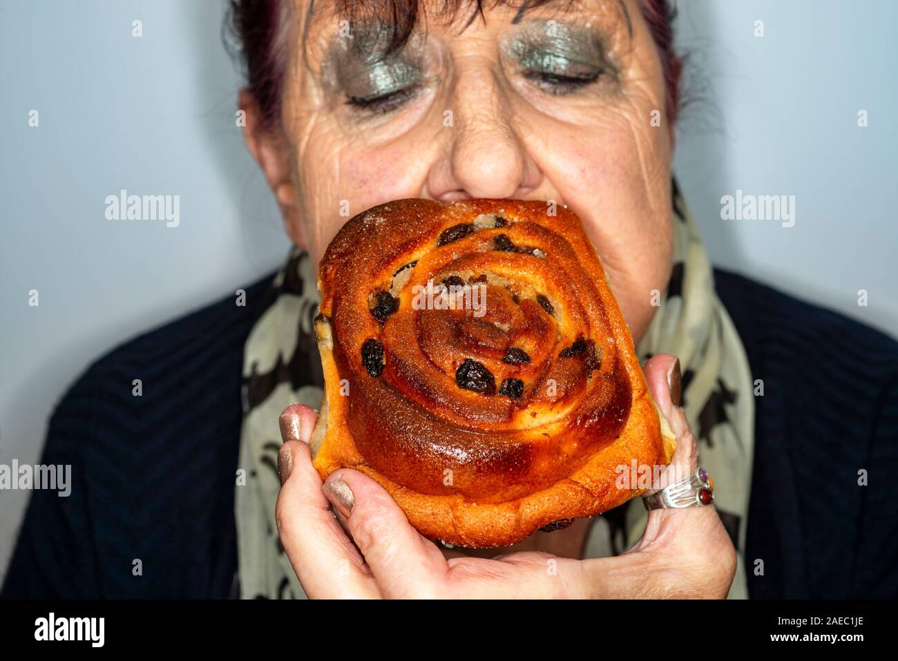Elderly woman eating bun hi-res stock photography and images - Alamy