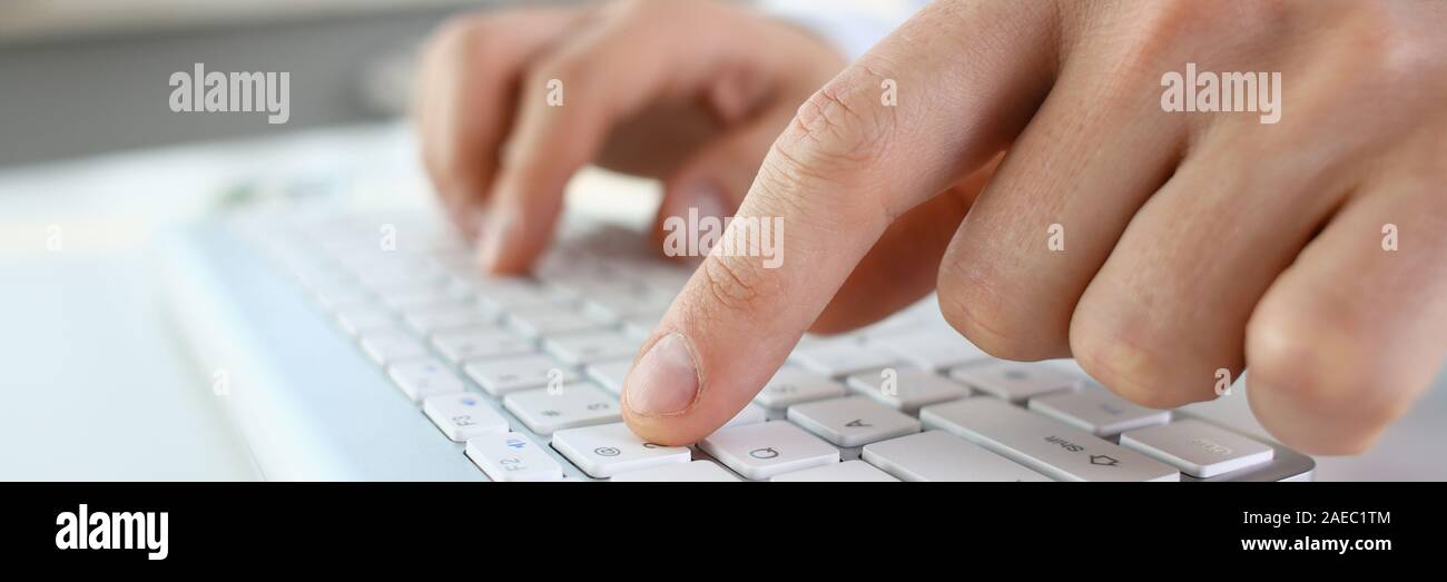 Male arms in suit typing on silver keyboard Stock Photo - Alamy