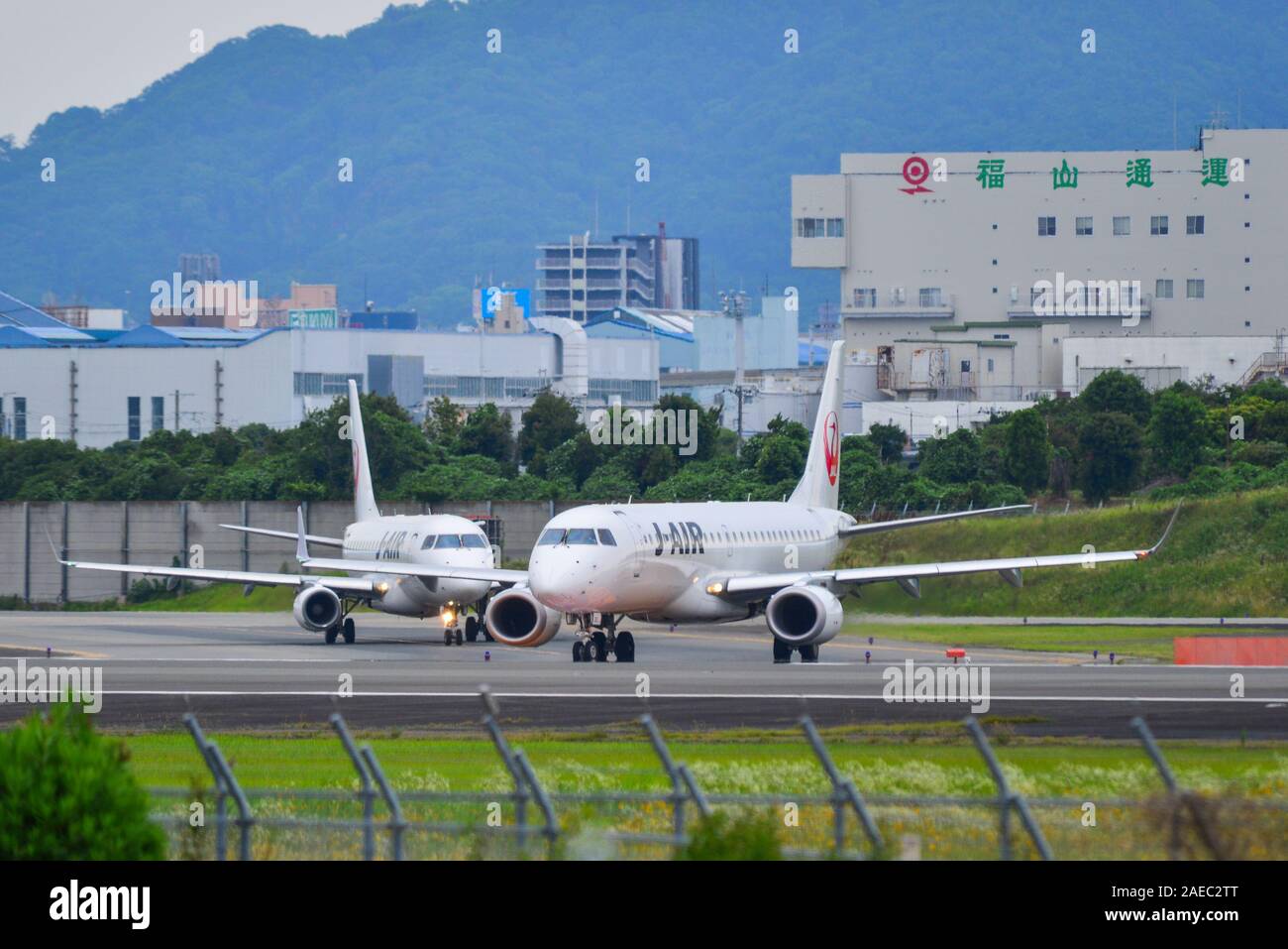 Osaka, Japan - Jun 26, 2019. Passenger airplanes taxiing on runway of ...