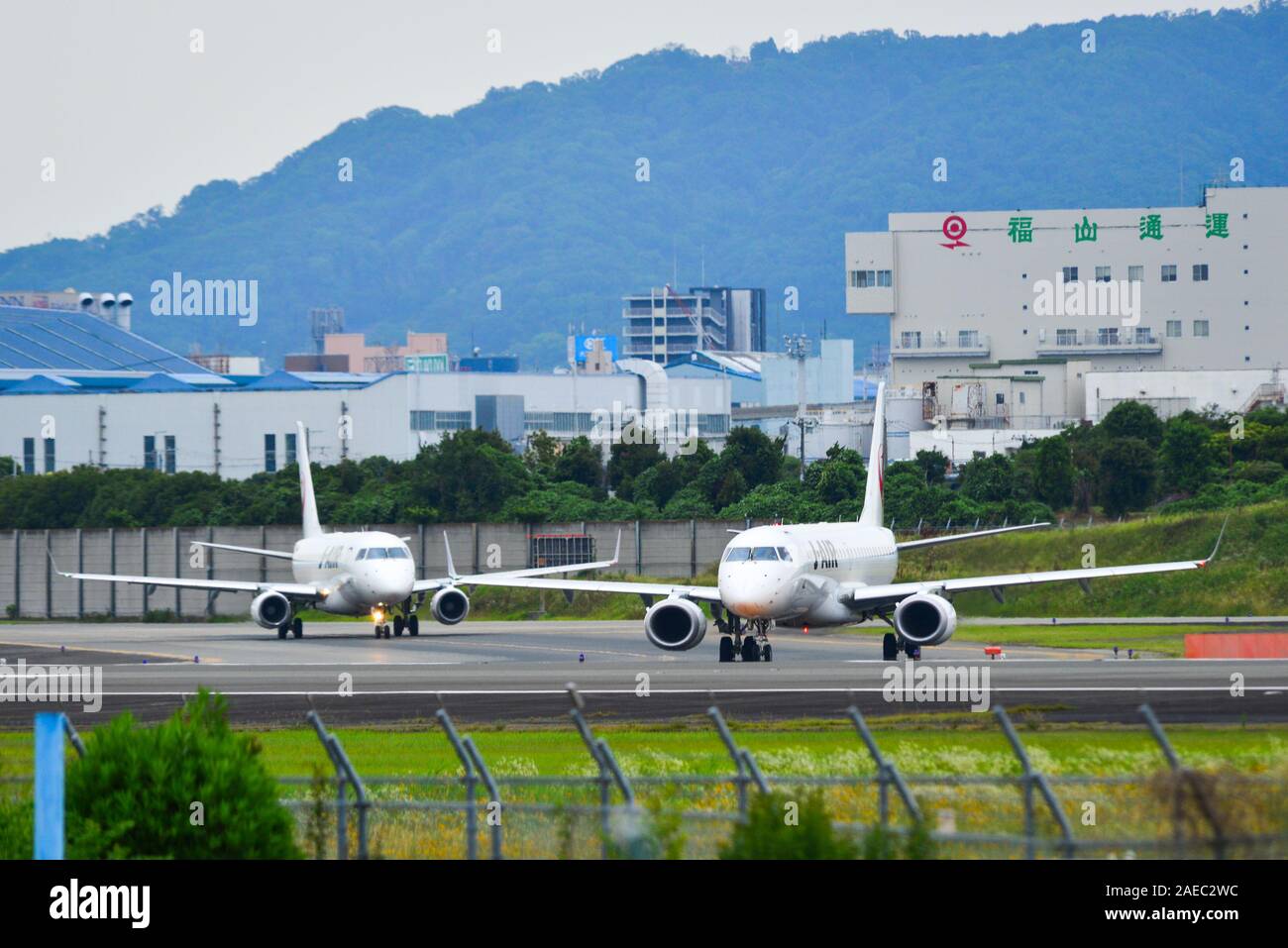 Osaka, Japan - Jun 26, 2019. Passenger airplanes taxiing on runway of ...