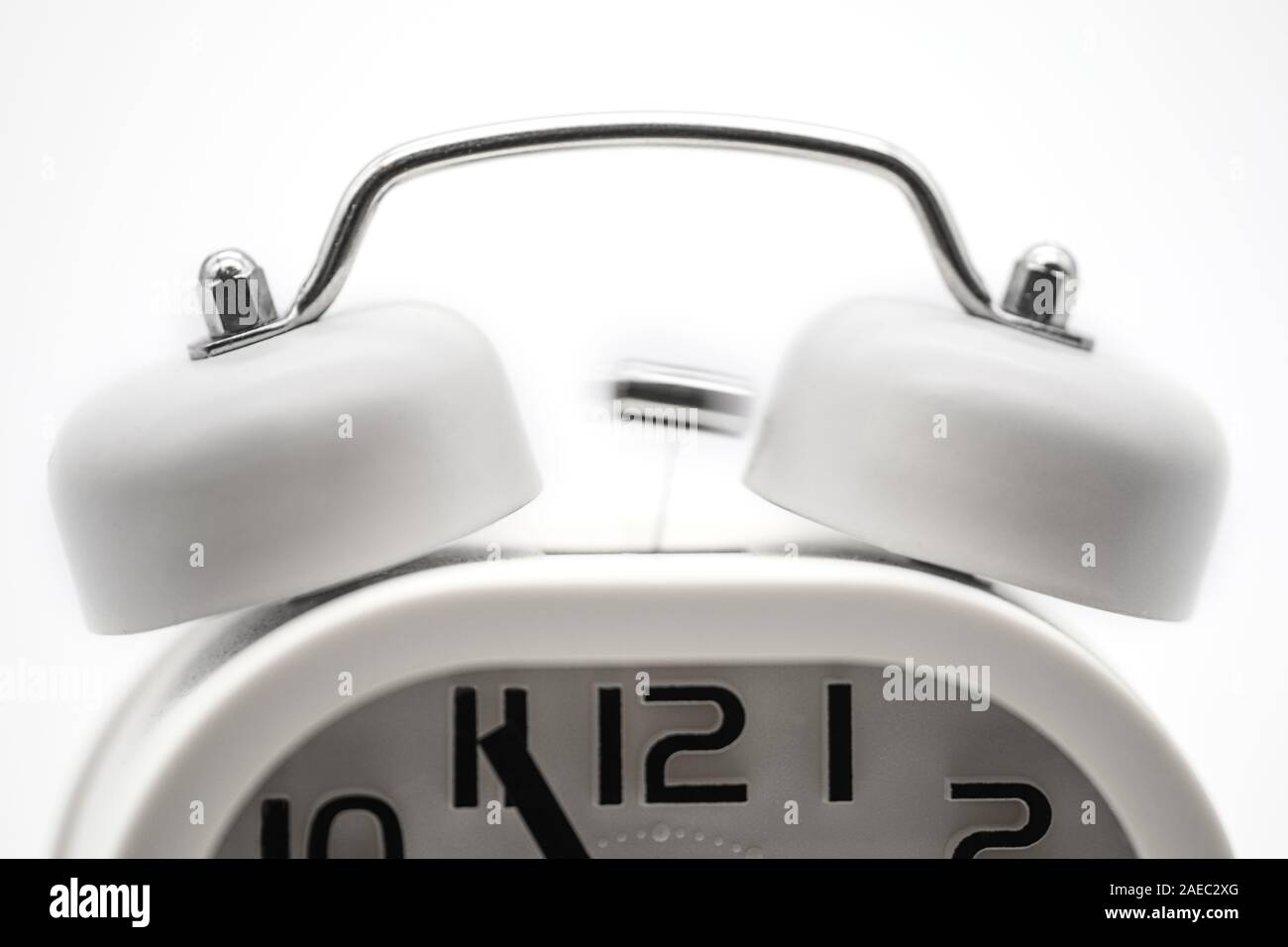 Upper view of a white ringing alarm clock isolated on white background ...