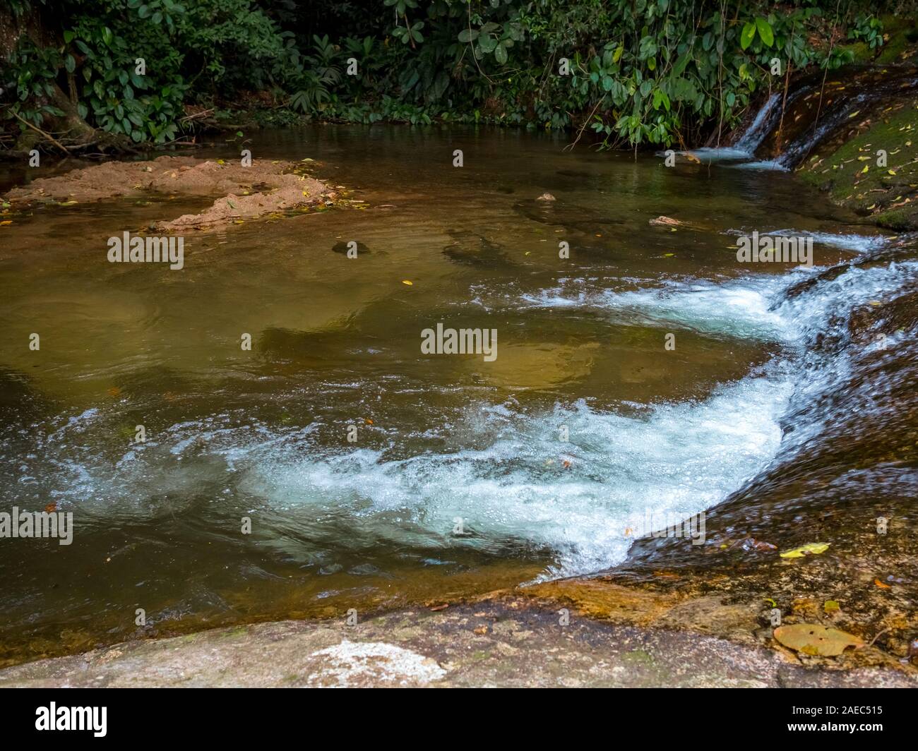Small waterfall with natural pool in crystal clear water, inside ...