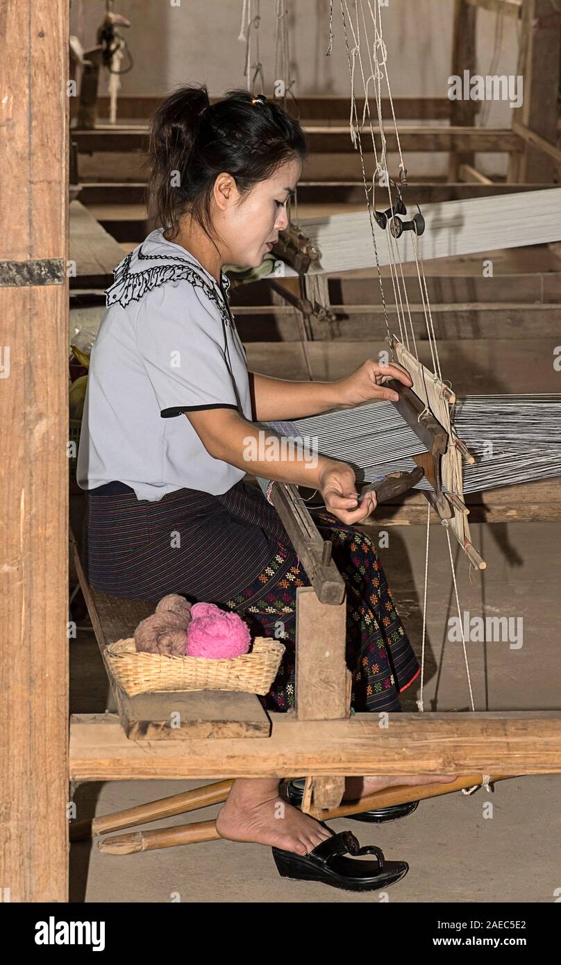 Young woamn weaving on a traditional Lao-Thai style loom, Ban Phanom ...