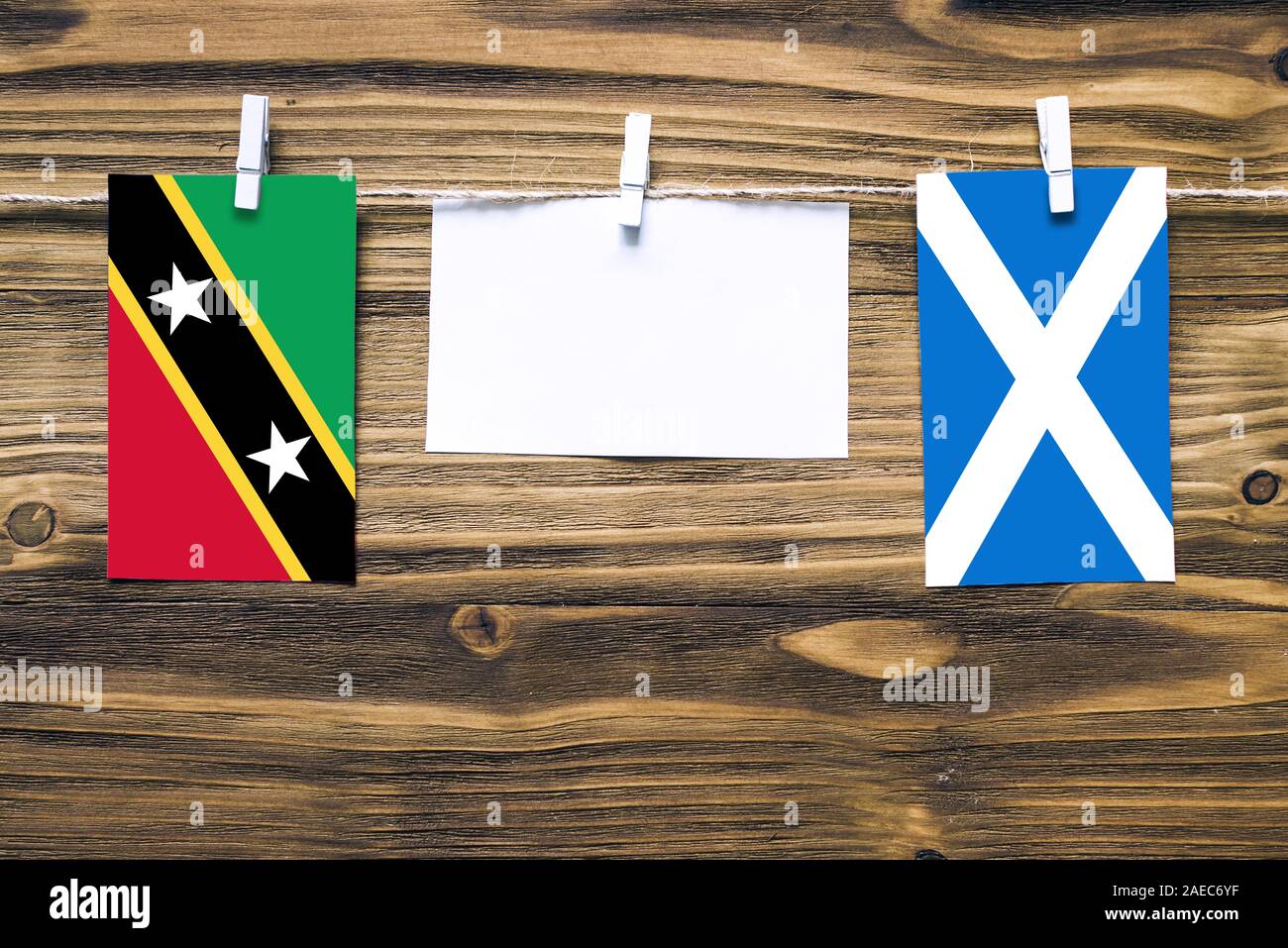 Hanging flags of Saint Kitts And Nevis and Scotland attached to rope ...