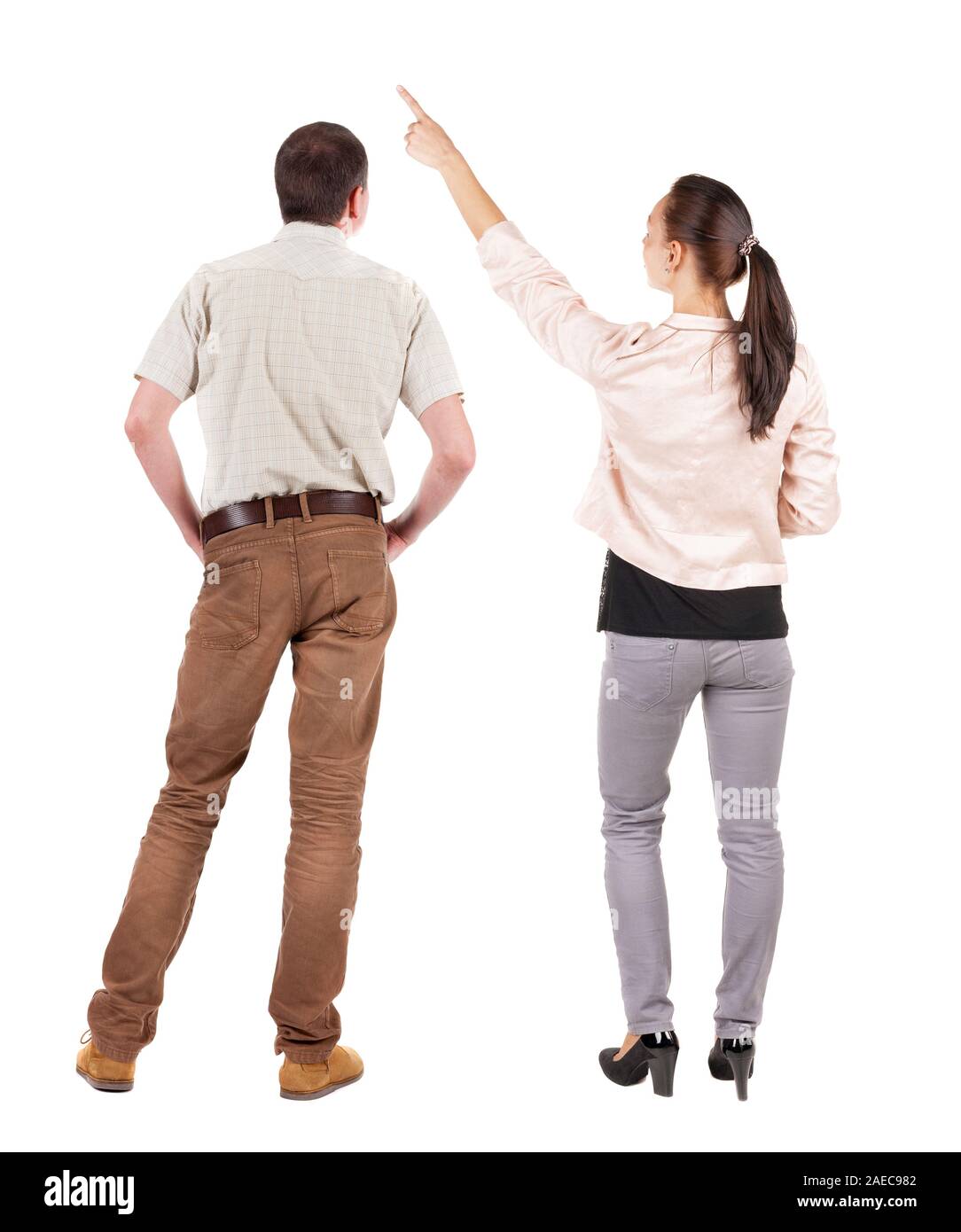 Back view of a stylish couple pointing. beautiful friendly girl and guy ...