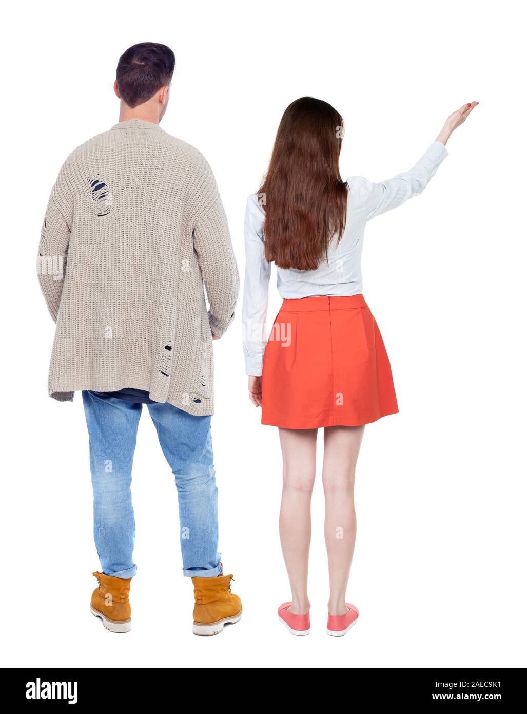 Back view of a stylish couple pointing. beautiful friendly girl and guy ...