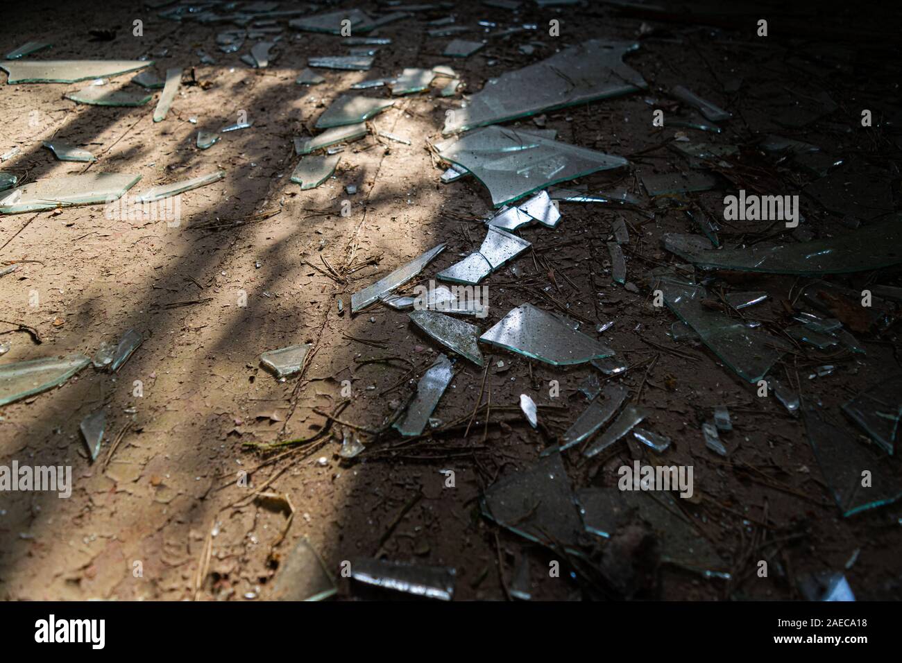 Shattered glass window on the ground Stock Photo - Alamy