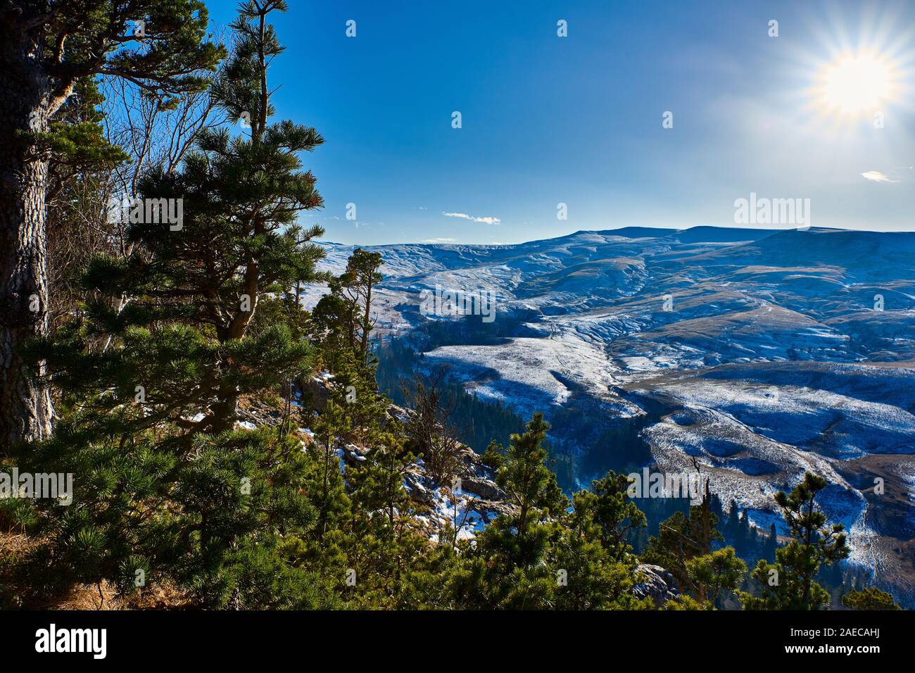 The bright sun illuminates the snowy mountain plateau. In the ...