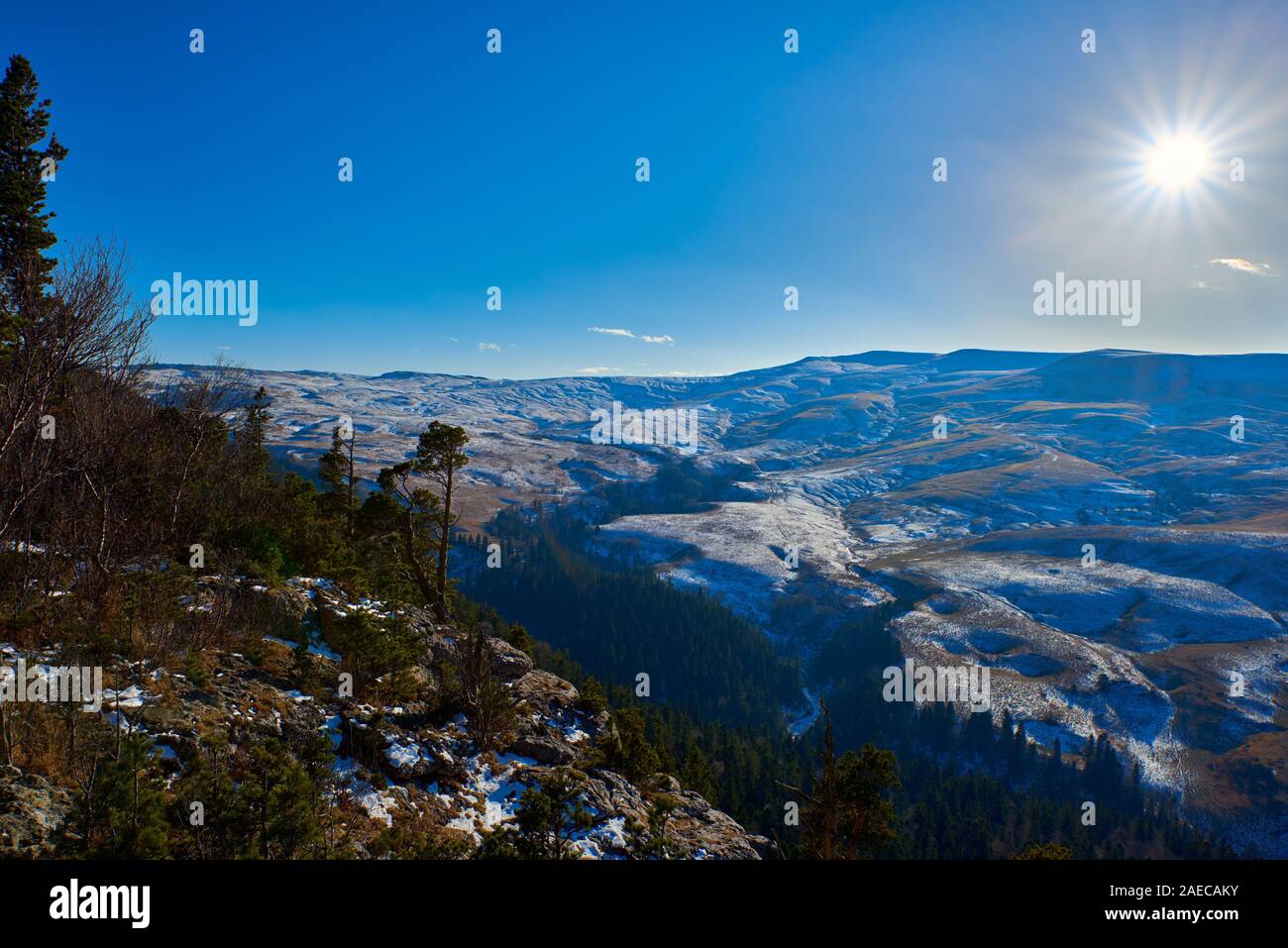 The bright sun illuminates the snowy mountain plateau. In the ...