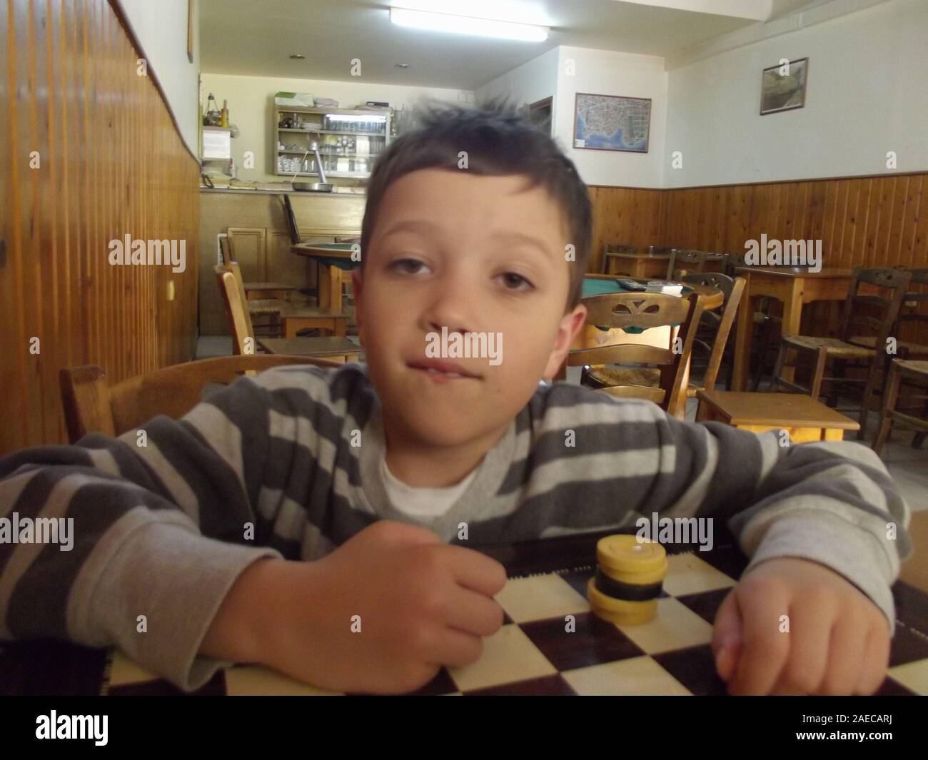 Boy in a traditional greek kafenion Crete, Greece Stock Photo - Alamy