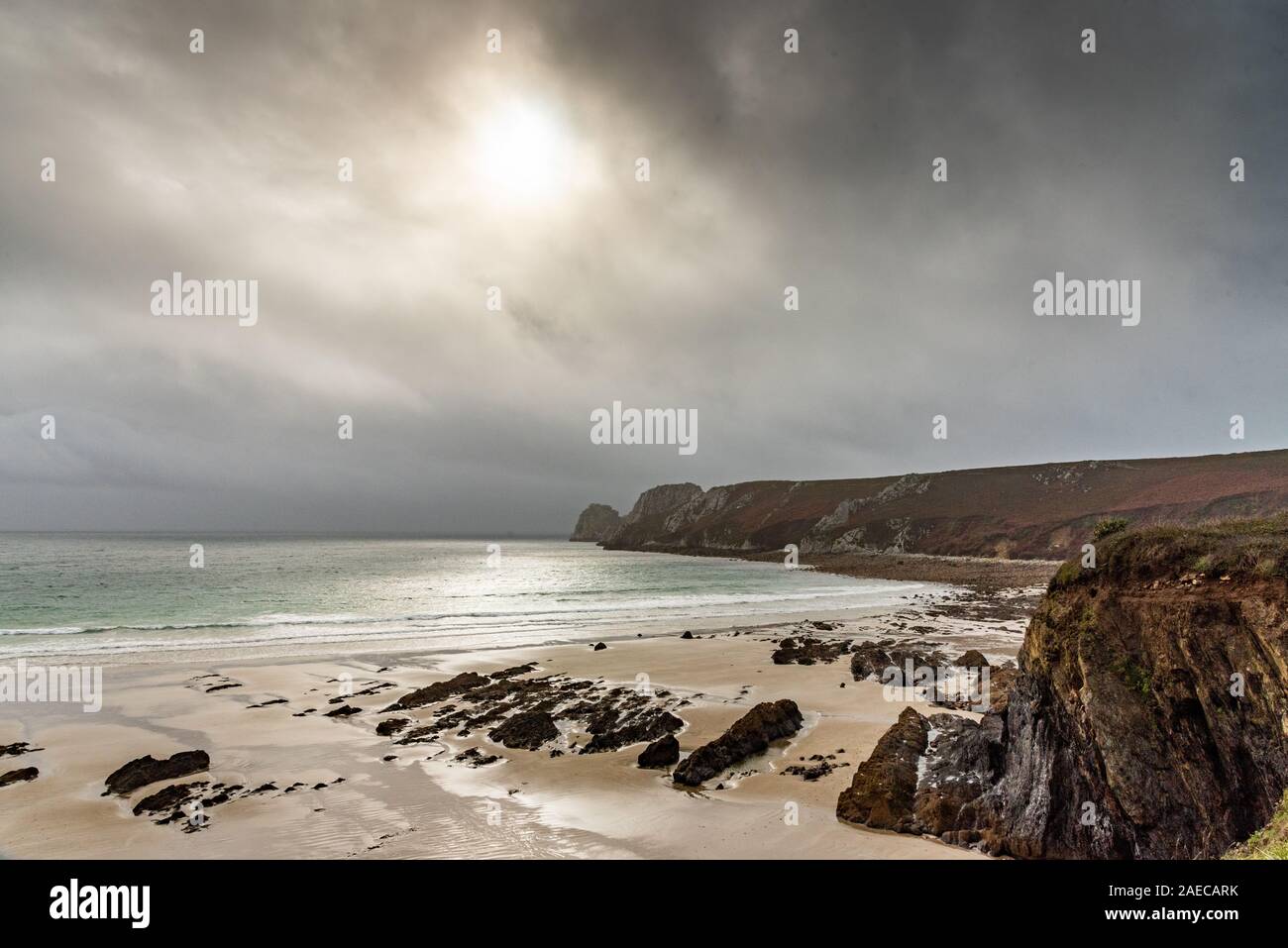 Sandy beach and rocks of Brittany in winter. The wind is rising and the ...