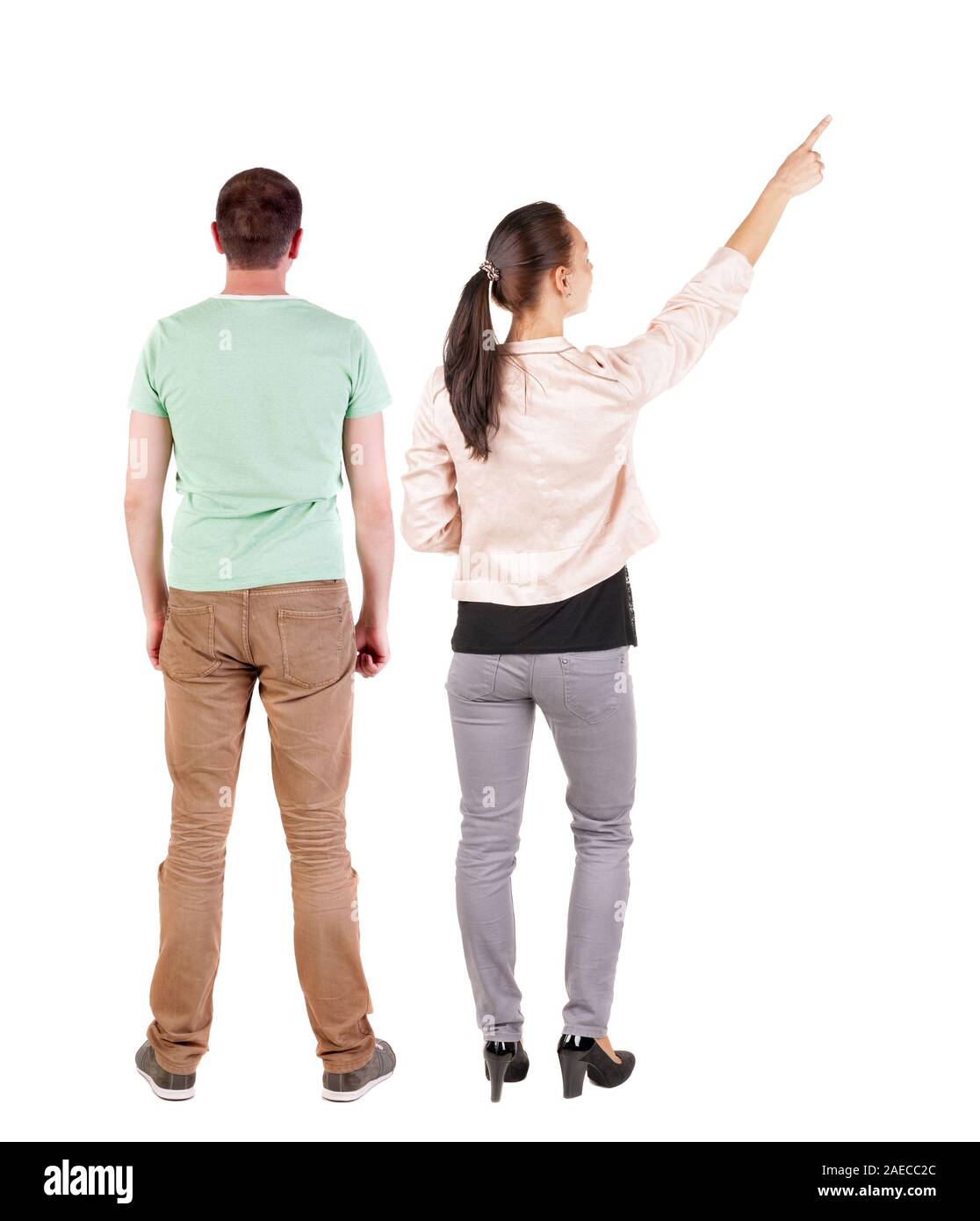 Back view of a stylish couple pointing. beautiful friendly girl and guy ...