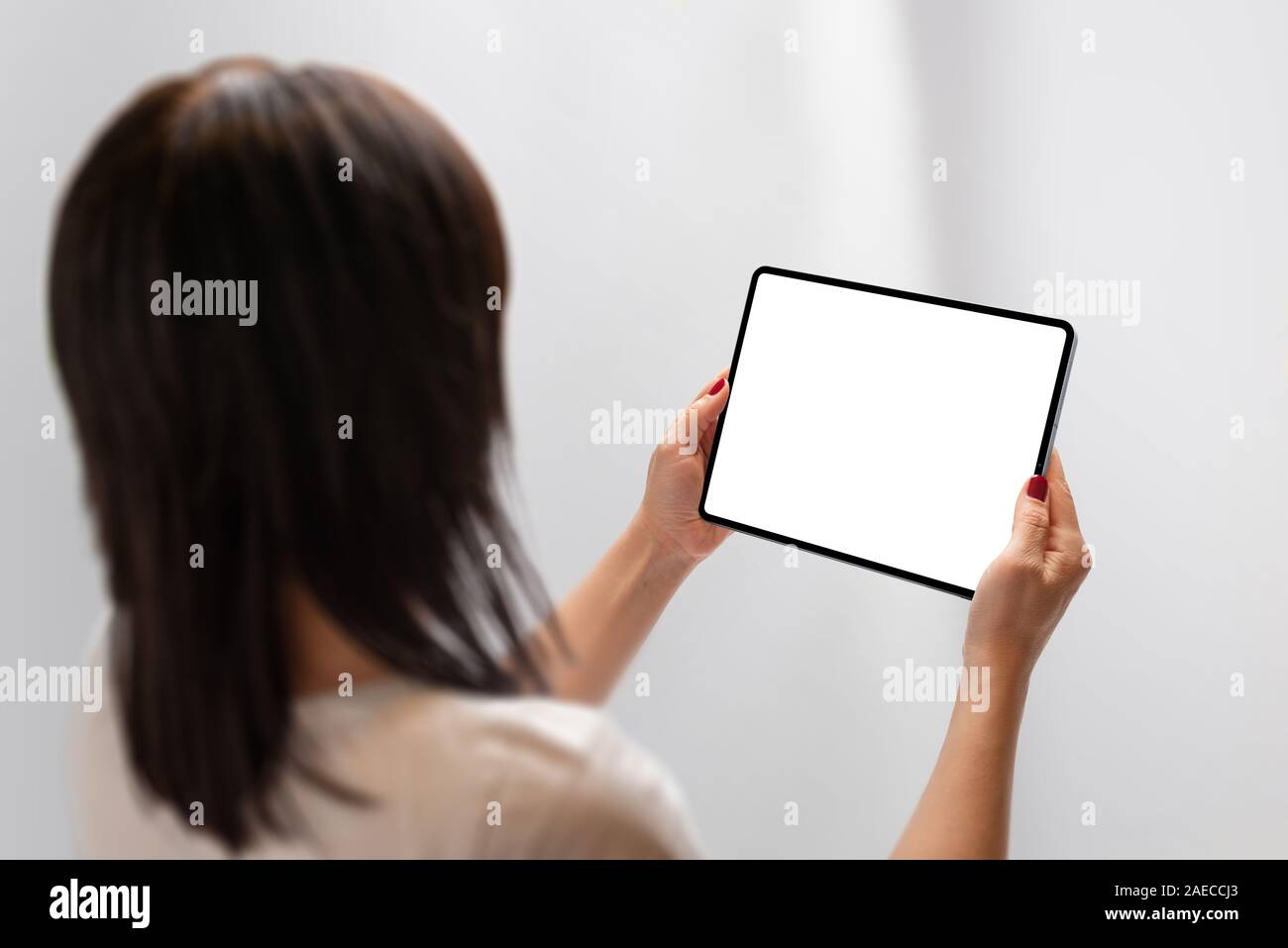 Girl holding tablet with isolated screen for mockup. Moder tablet with ...