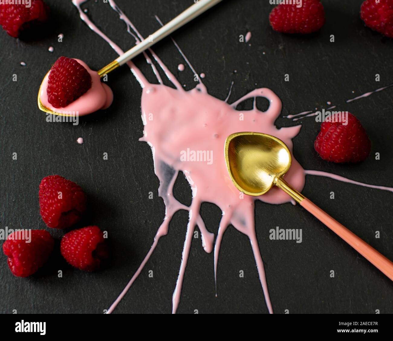 Bright pink yogurt splashes on a dark background Stock Photo - Alamy