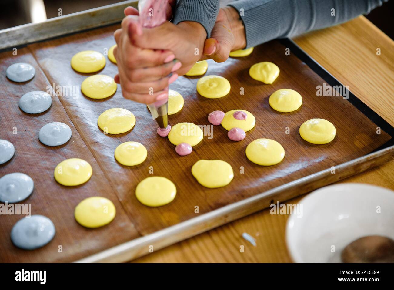 French macaroon cooking master class in a kitchen with various people ...