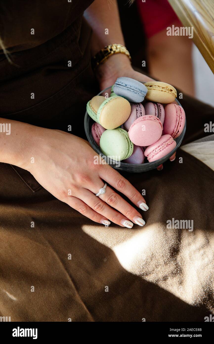 French macaroon cooking master class in a kitchen with various people ...