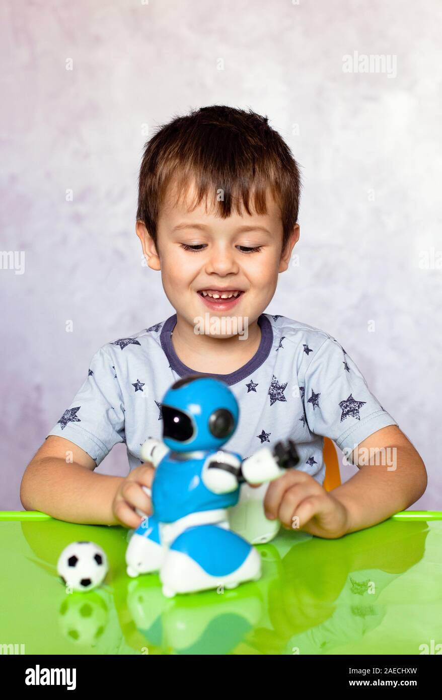 Little boy is playing with robot. Robot for children. Smart toy Stock ...