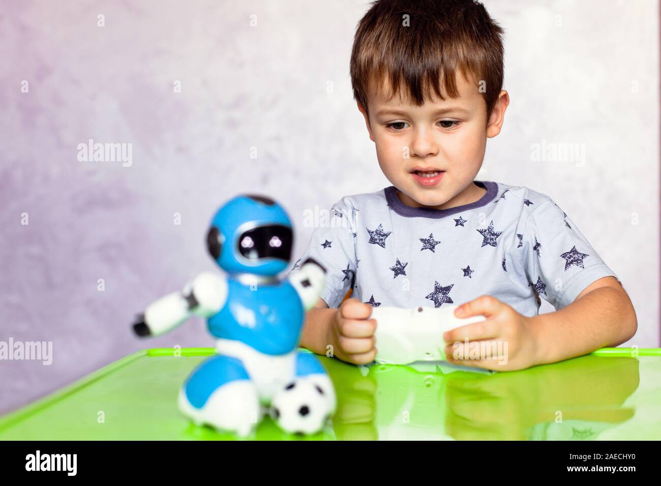 Little boy is playing with robot. Robot for children. Smart toy Stock ...