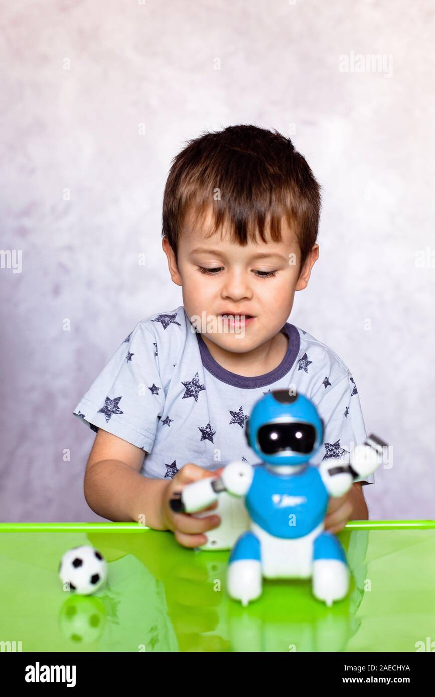 Little boy is playing with robot. Robot for children. Smart toy Stock ...