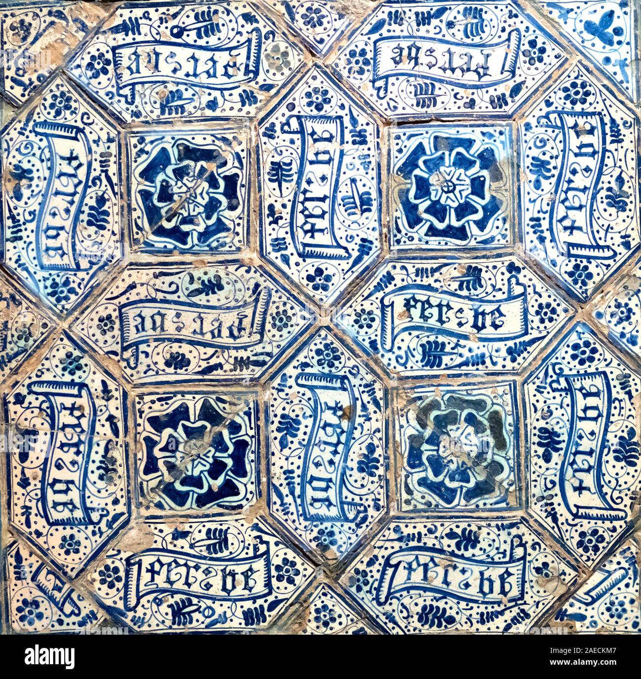 old tile wall with geometric patterns, flowers and texts in blue Stock ...