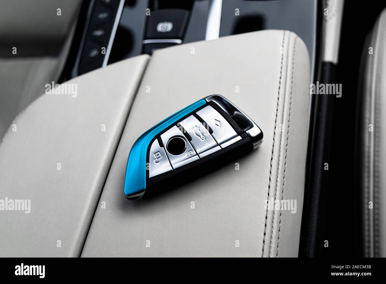 Closeup inside vehicle of wireless key ignition on white perforated ...