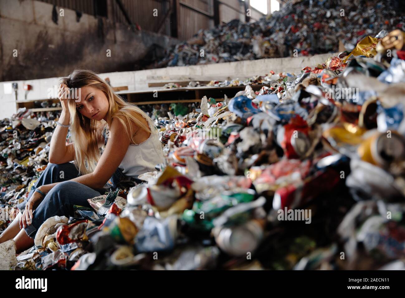 Laying down - Nature pollution activist at a huge trash dump - Young ...