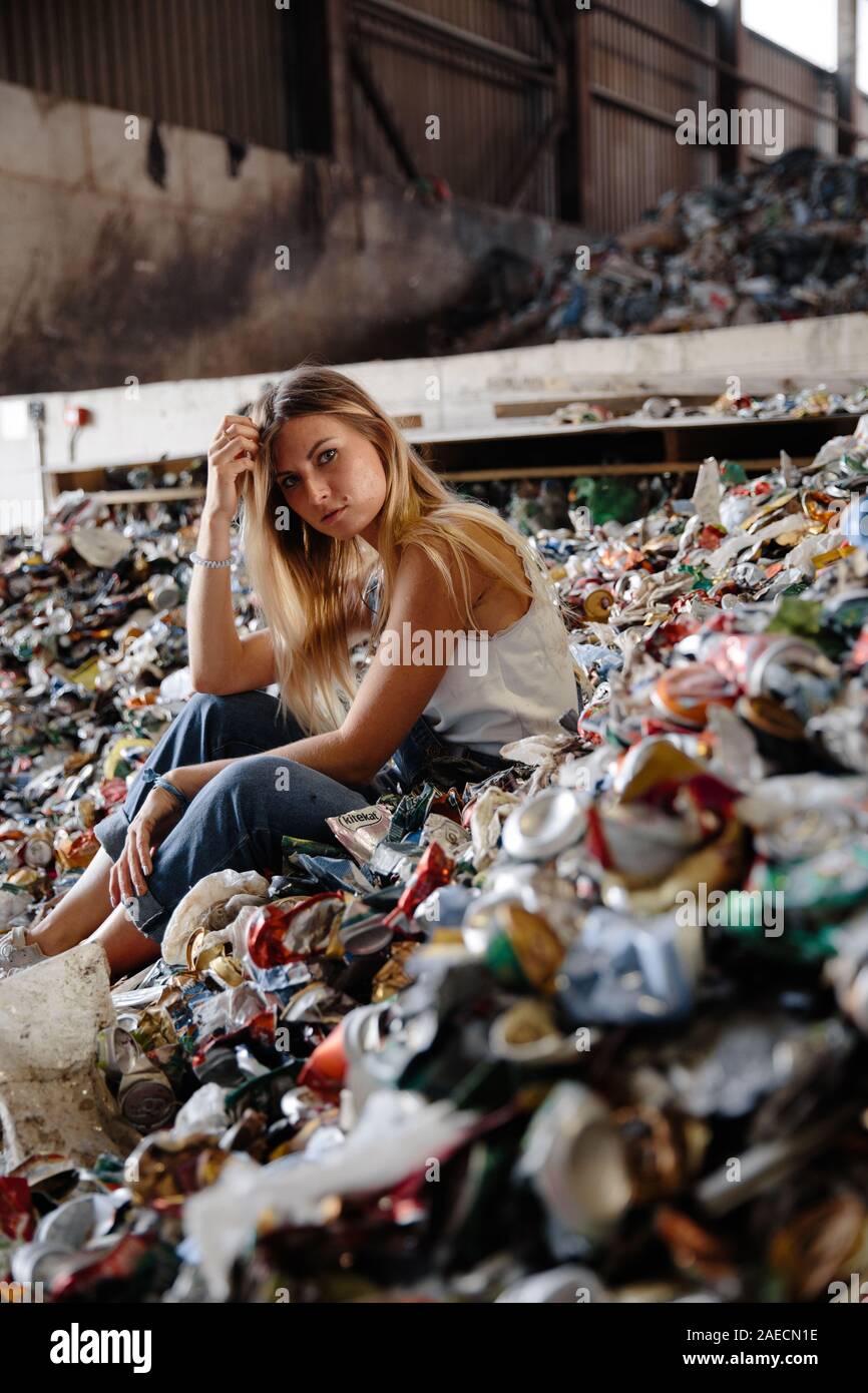 Laying down - Nature pollution activist at a huge trash dump - Young ...