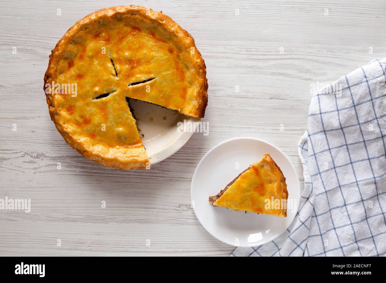 Homemade Canadian Tourtiere(Holiday Meat Pie) on a white wooden table ...