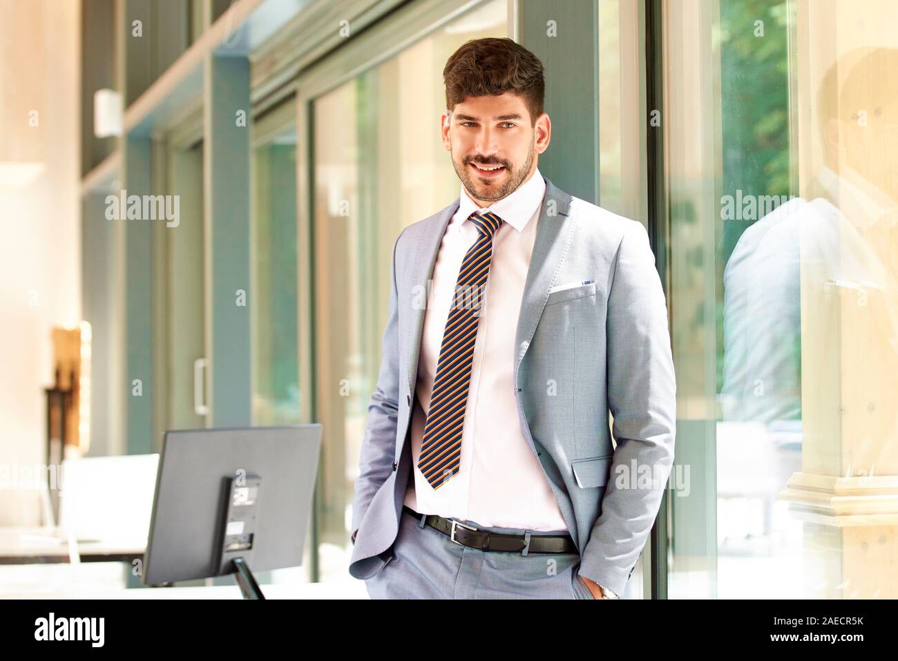 Portrait of successful businessman wearing suit and tie while standing ...