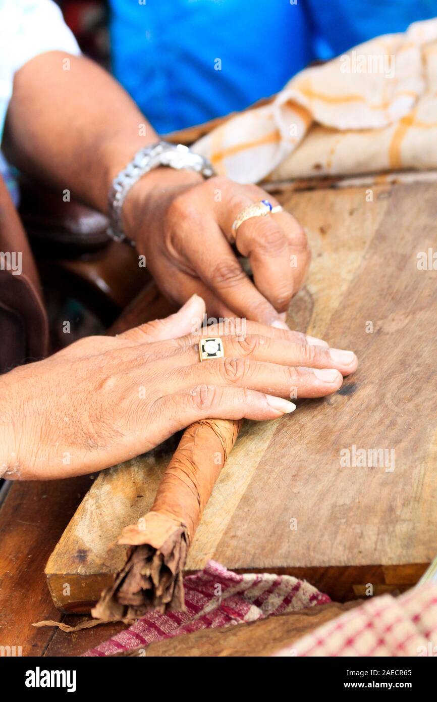 Wrap your hands in cigars Stock Photo - Alamy