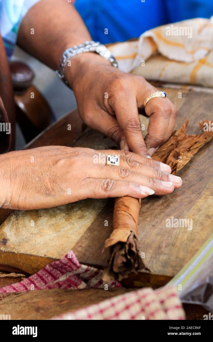 Wrap your hands in cigars Stock Photo - Alamy