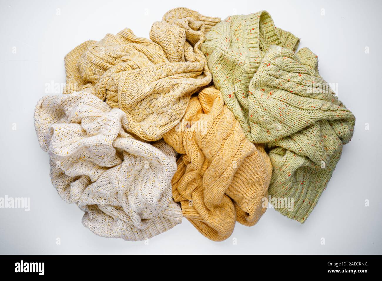 Pile of Knitted Sweaters on a White Background Stock Photo - Alamy