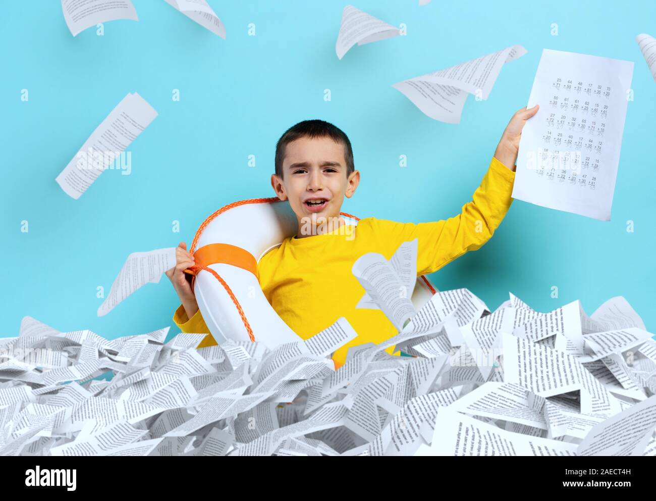 Young boy student is drowning in a sea of sheets of exercises. Cyan ...