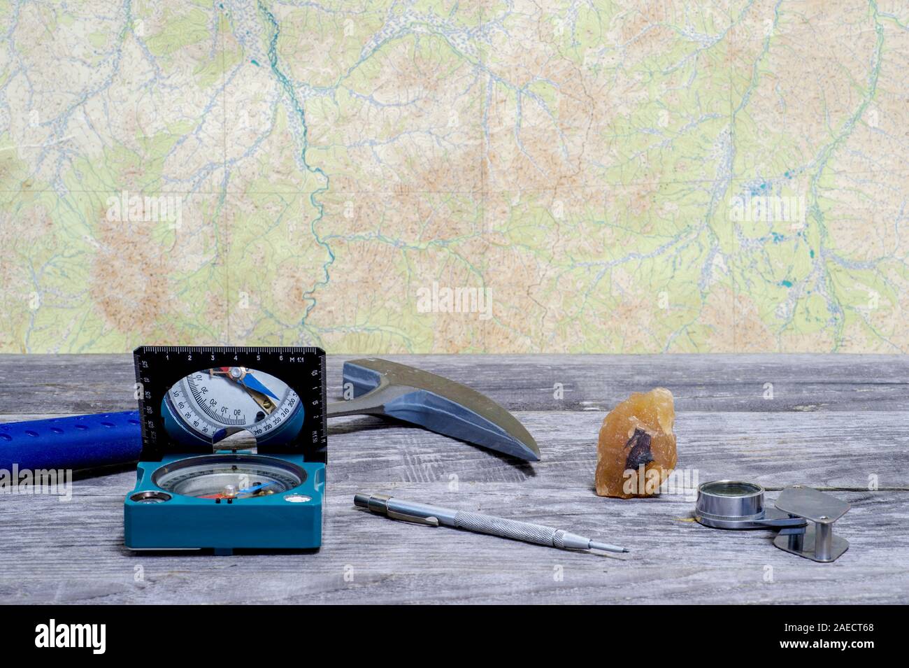 Tools geologist laid out on a wooden table on the background of a ...