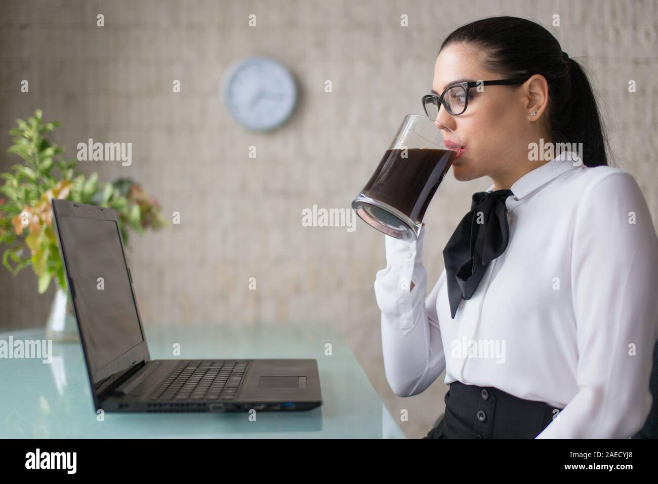 Young 20s businesswoman employee in formal wear drinking coffee in ...