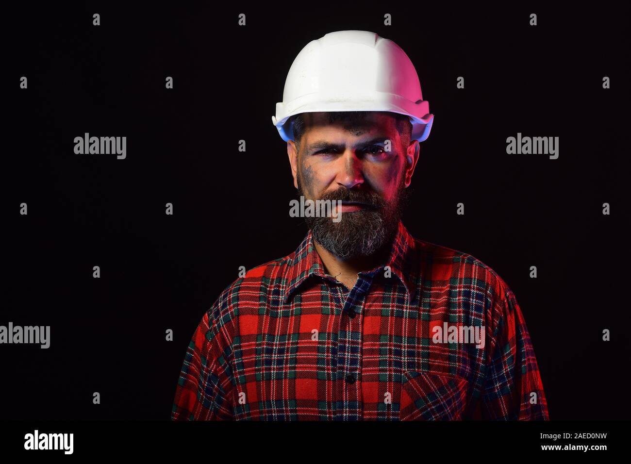 Man with calm face expression isolated on black background. Worker with ...
