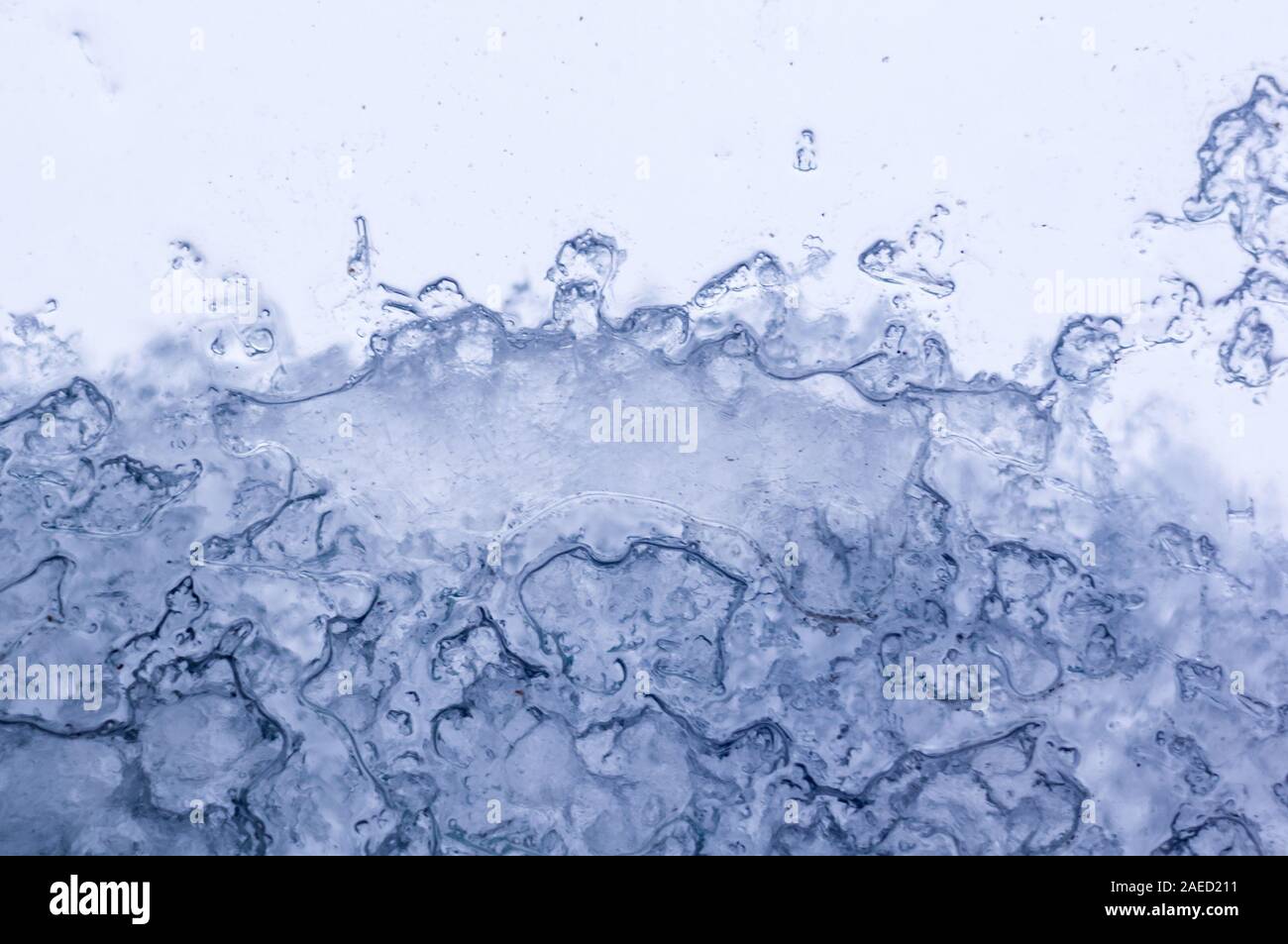 glass in the window covered with wet melting snow, close-up, macro ...