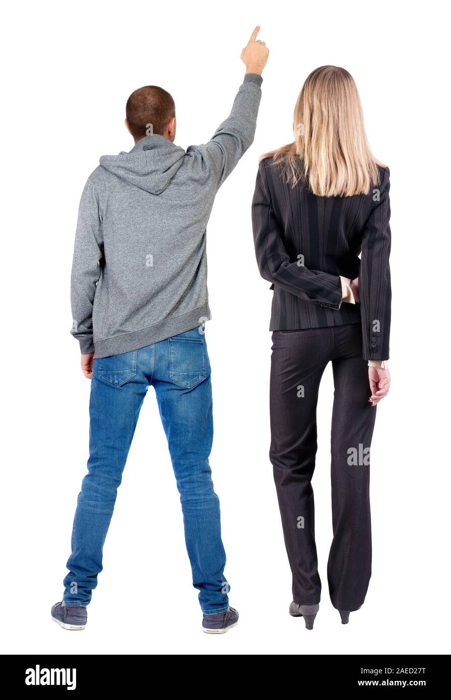 Back view of a stylish couple pointing. beautiful friendly girl and guy ...