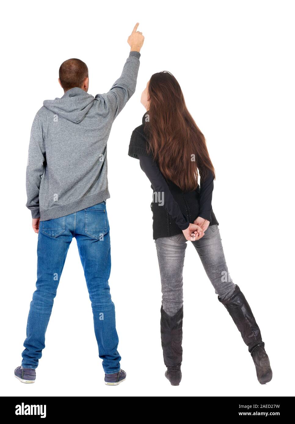 Back view of a stylish couple pointing. beautiful friendly girl and guy ...