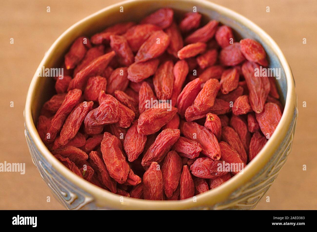 Dried Goji Berries (Lycium barbarum) in a small green ceramic bowl ...