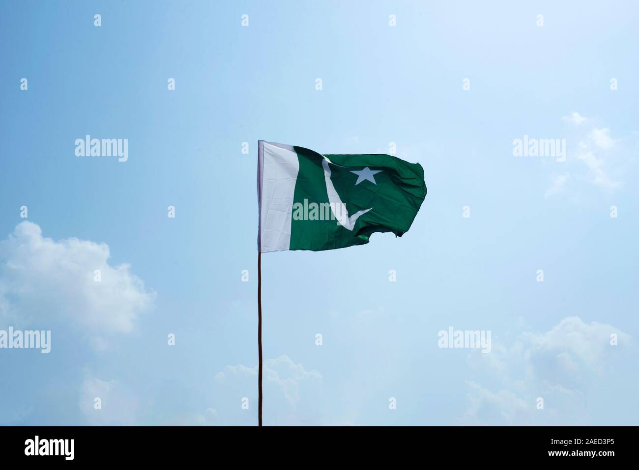 The national flag of Pakistan flying in the blue sky with clouds Stock ...