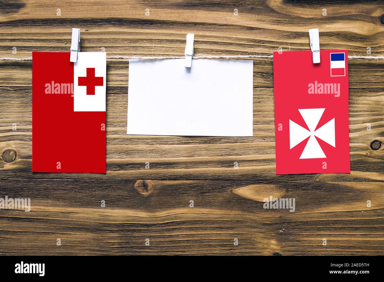 Hanging flags of Tonga and Wallis And Futuna attached to rope with ...