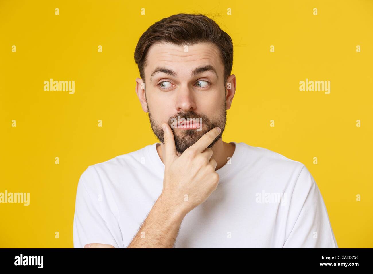 Thinking man isolated on yellow background. Closeup portrait of a ...