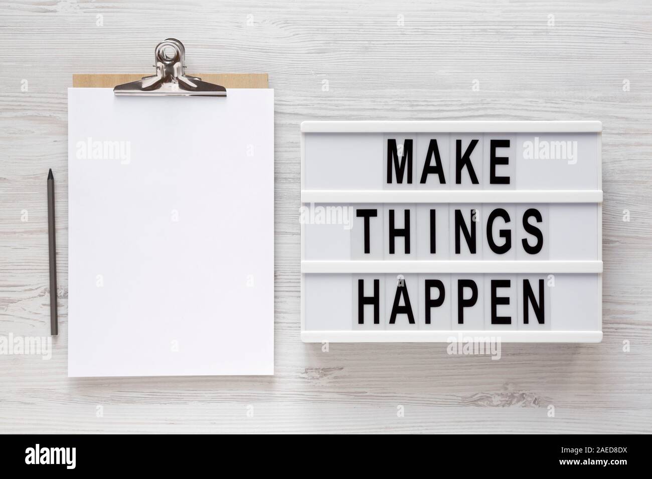 'Make things happen' words on a modern board, clipboard with blank ...
